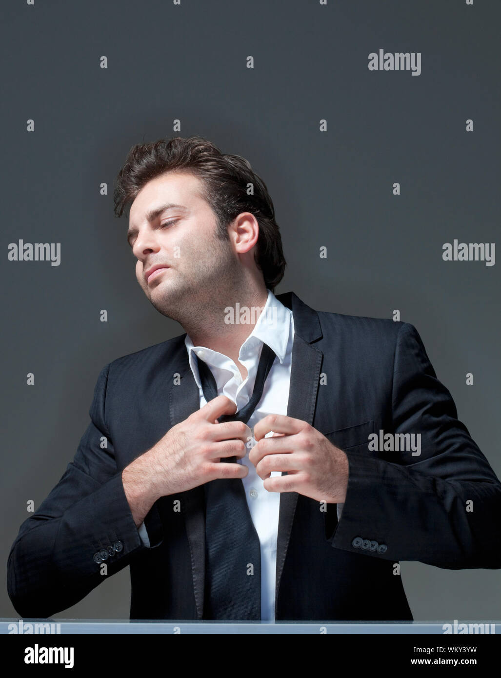 Man loosening tie hi-res stock photography and images - Alamy