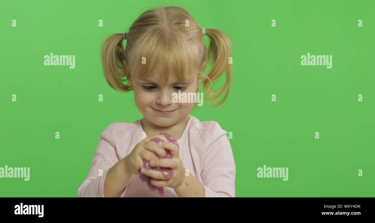 Child having fun making ping slime. Kid playing with hand made toy ...