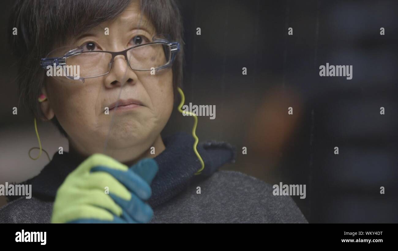 AMERICAN FACTORY, Hui-Mei inspecting glass in the Fuyao factory in ...