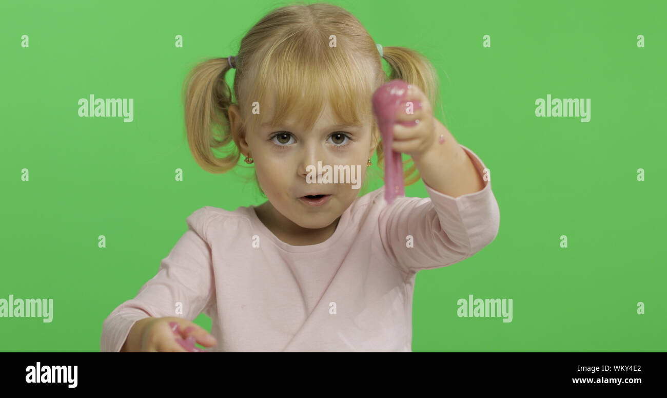 Child having fun making ping slime. Kid playing with hand made toy ...