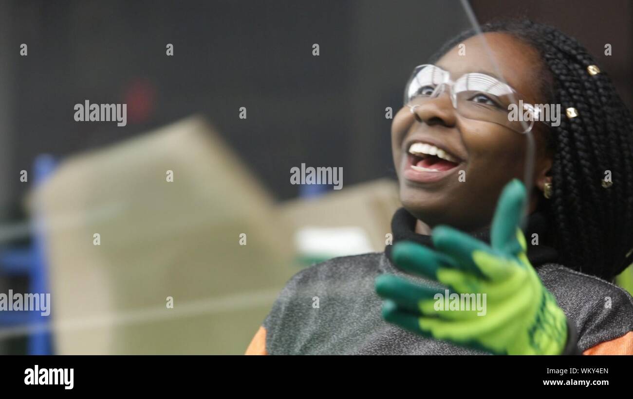 AMERICAN FACTORY, Tawana Smith inspecting glass in the Fuyao factory in ...