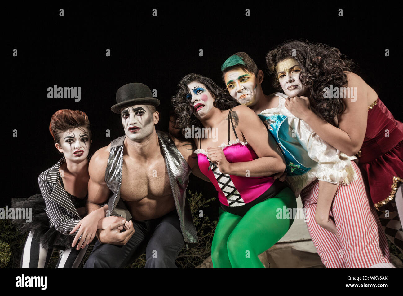Group of crying cirque clowns on stage Stock Photo - Alamy