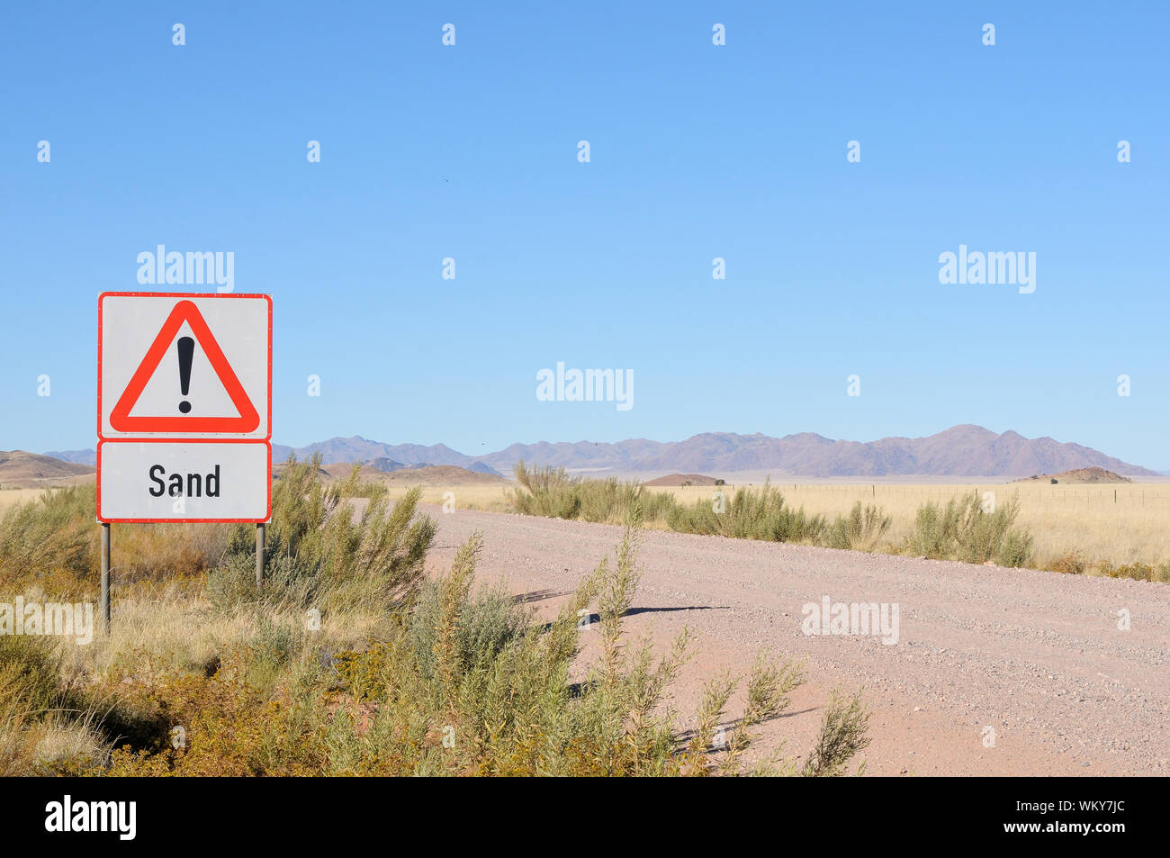 Sand in road warning sign on the C14 road in Namibia Stock Photo - Alamy