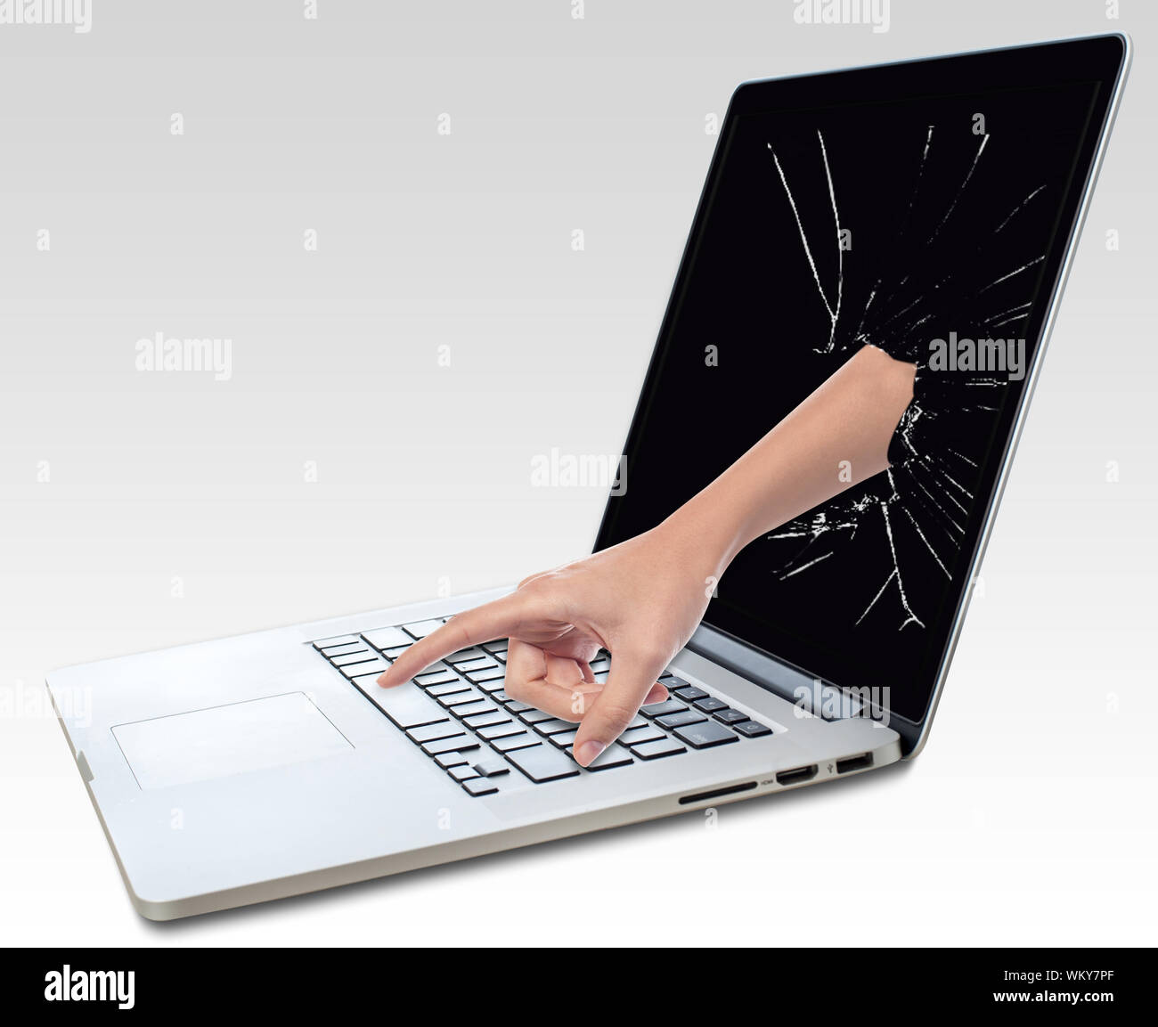 Hand peeping from broken laptop screen presses the button Stock Photo ...