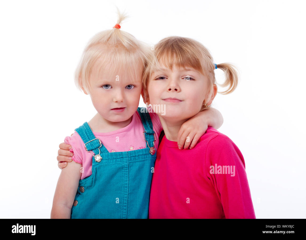 two sisters embracing each other, looking at camera - isolated on white ...