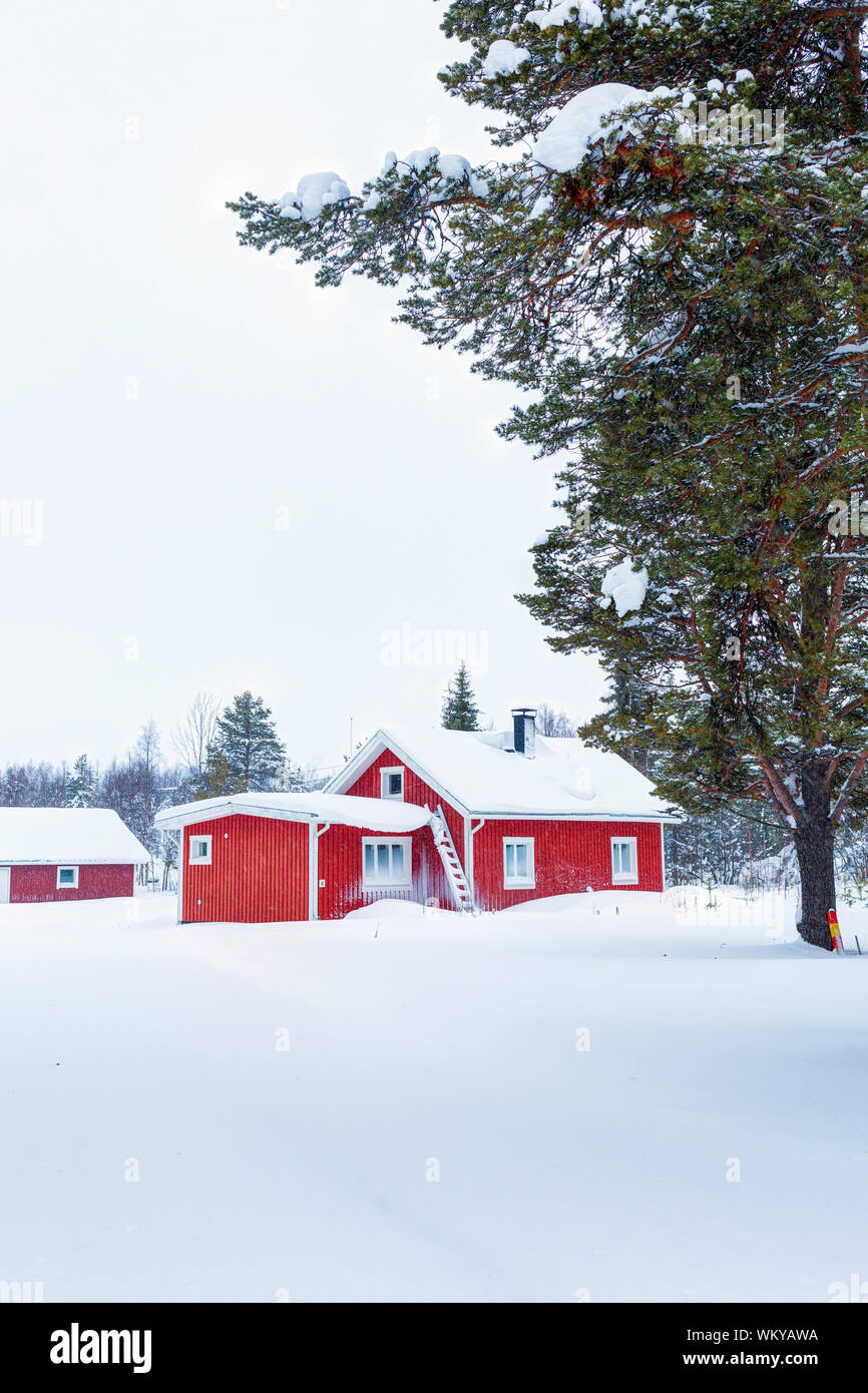 Red wooden Finnish house in winter forest covered with snow Stock Photo ...