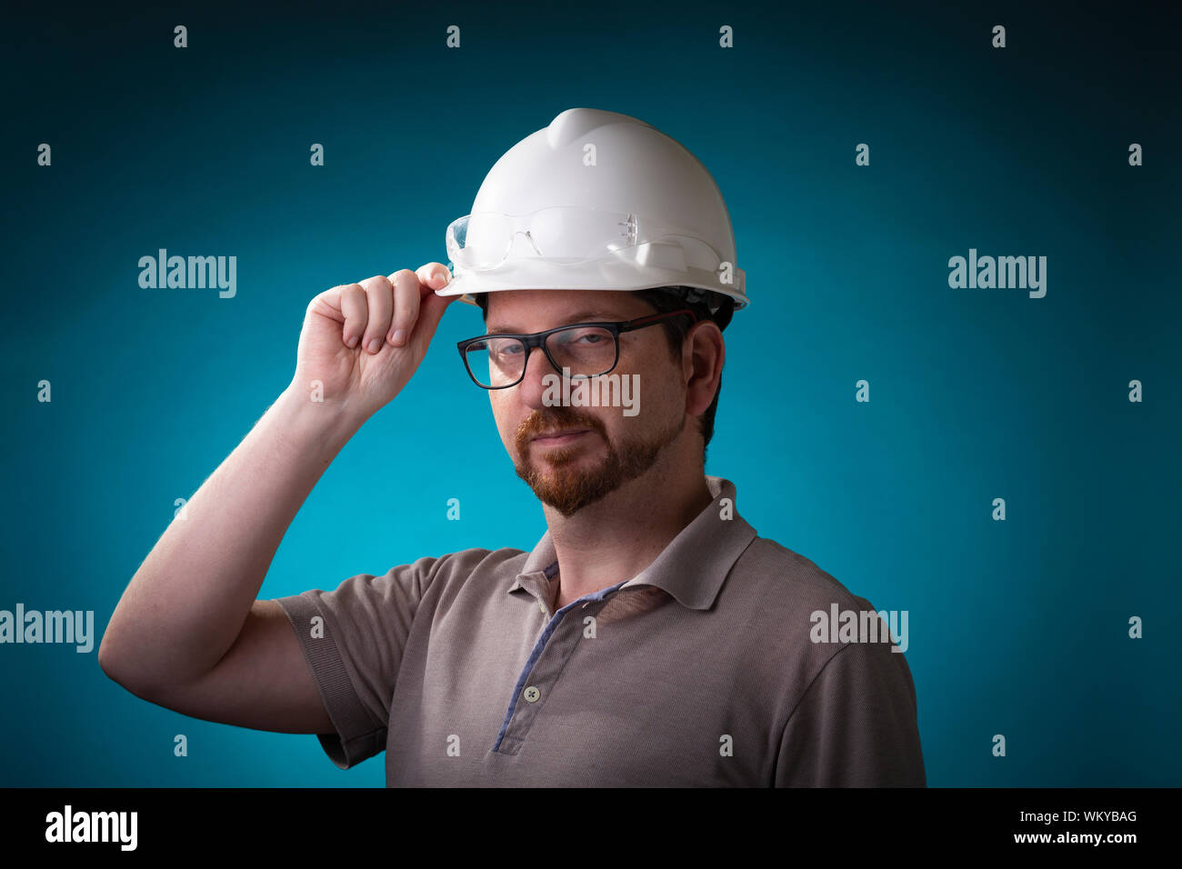 Male with goofy look, beard and glasses holding a protective ...