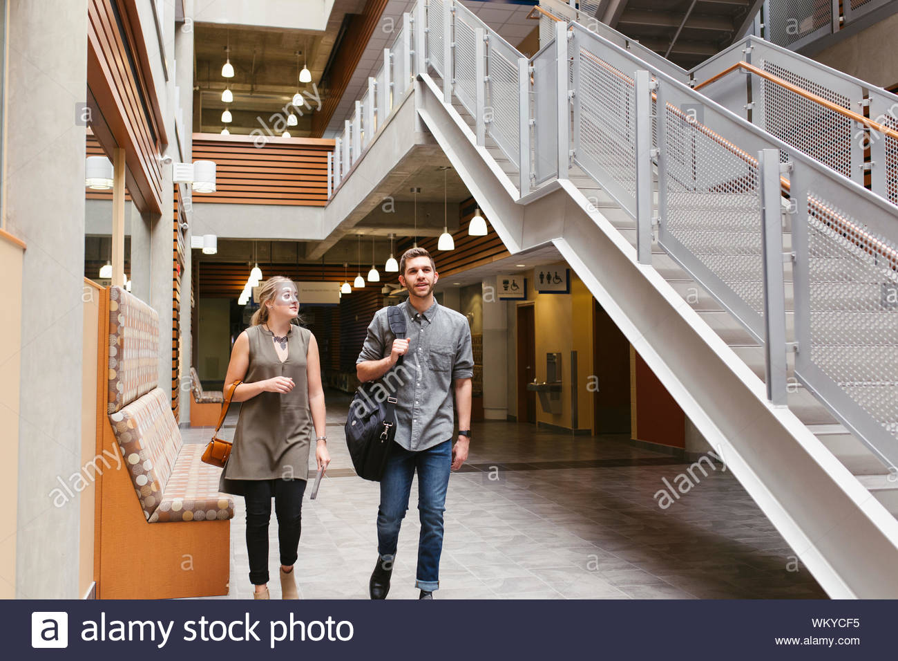 Walking in office atrium hi-res stock photography and images - Alamy