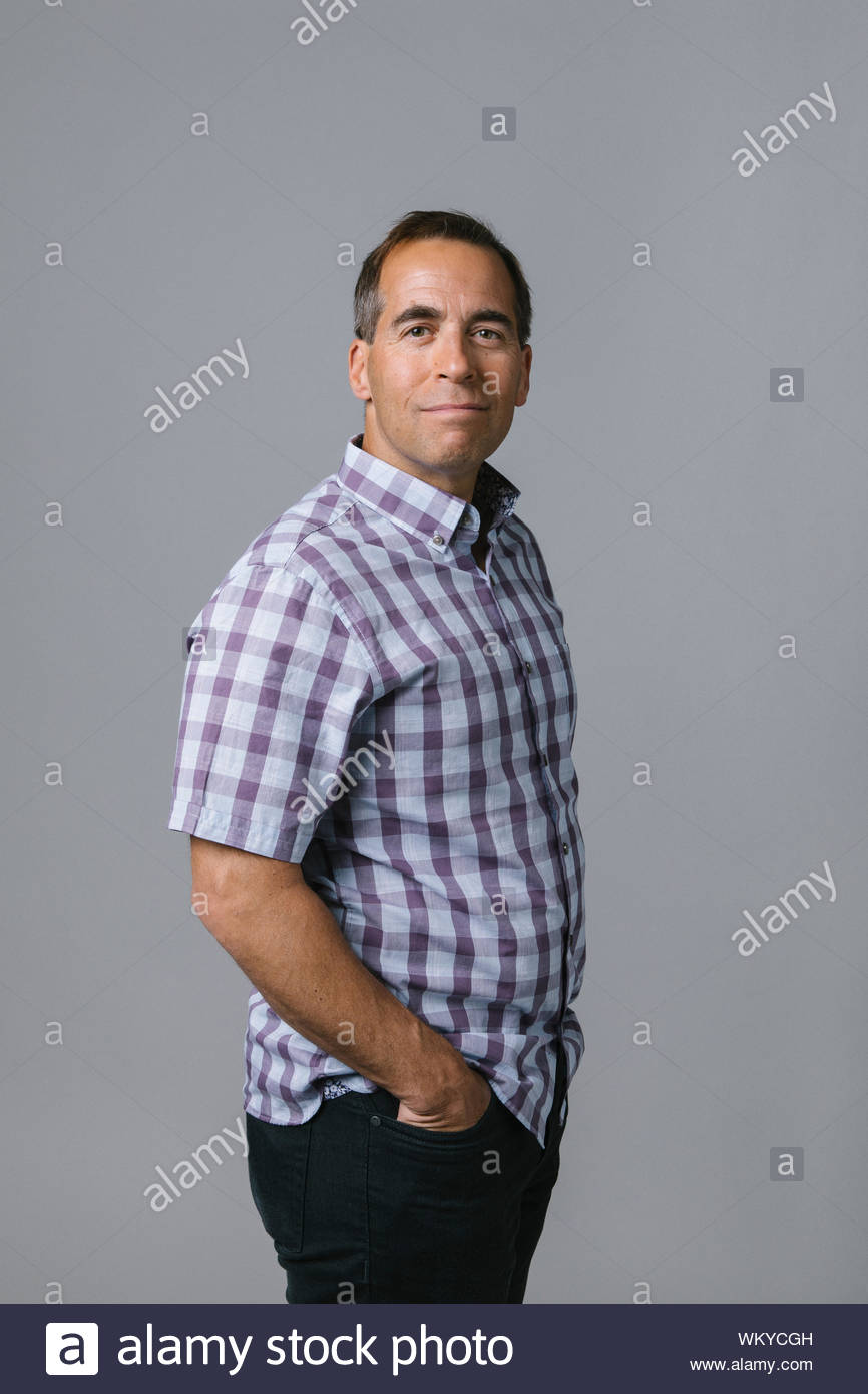 Smiling looking at camera standing hands in pockets hi-res stock ...