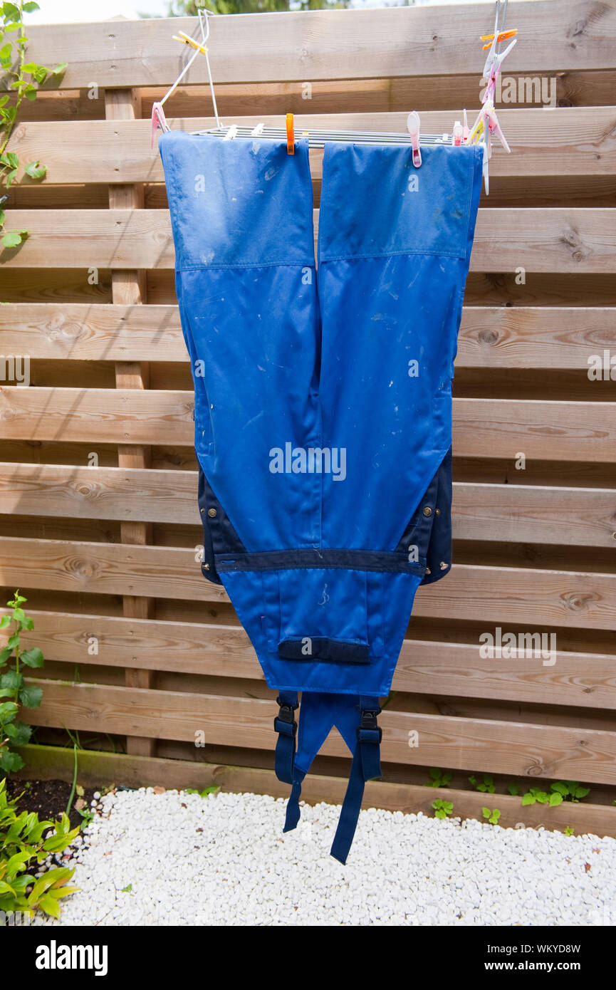 Blue workwear as laundry hanging in the garden Stock Photo - Alamy