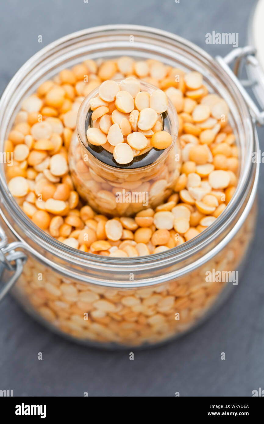 Yellow split peas in a glass jar Stock Photo - Alamy