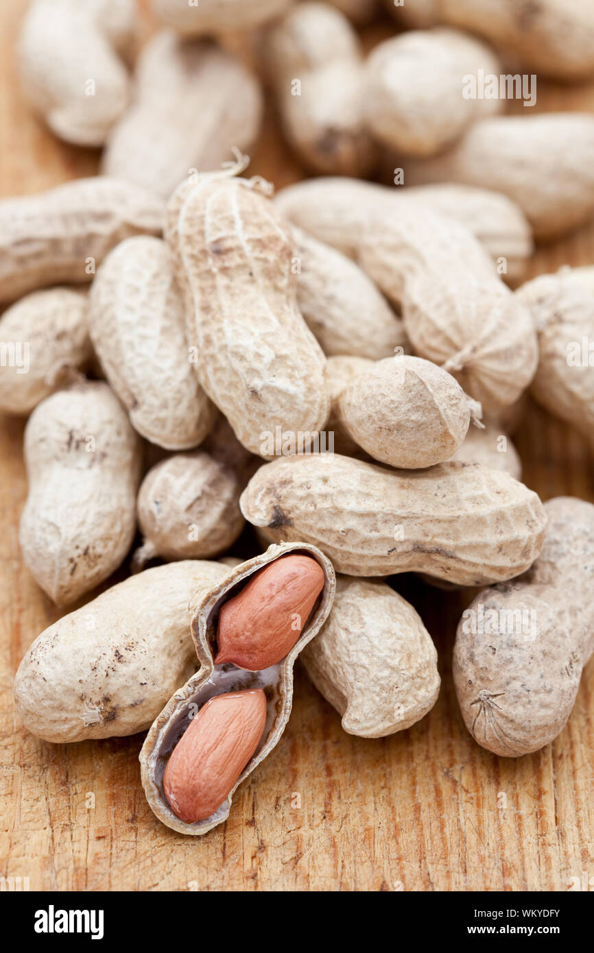 Peanuts known as also as monkey nuts in a shell on a board Stock Photo ...