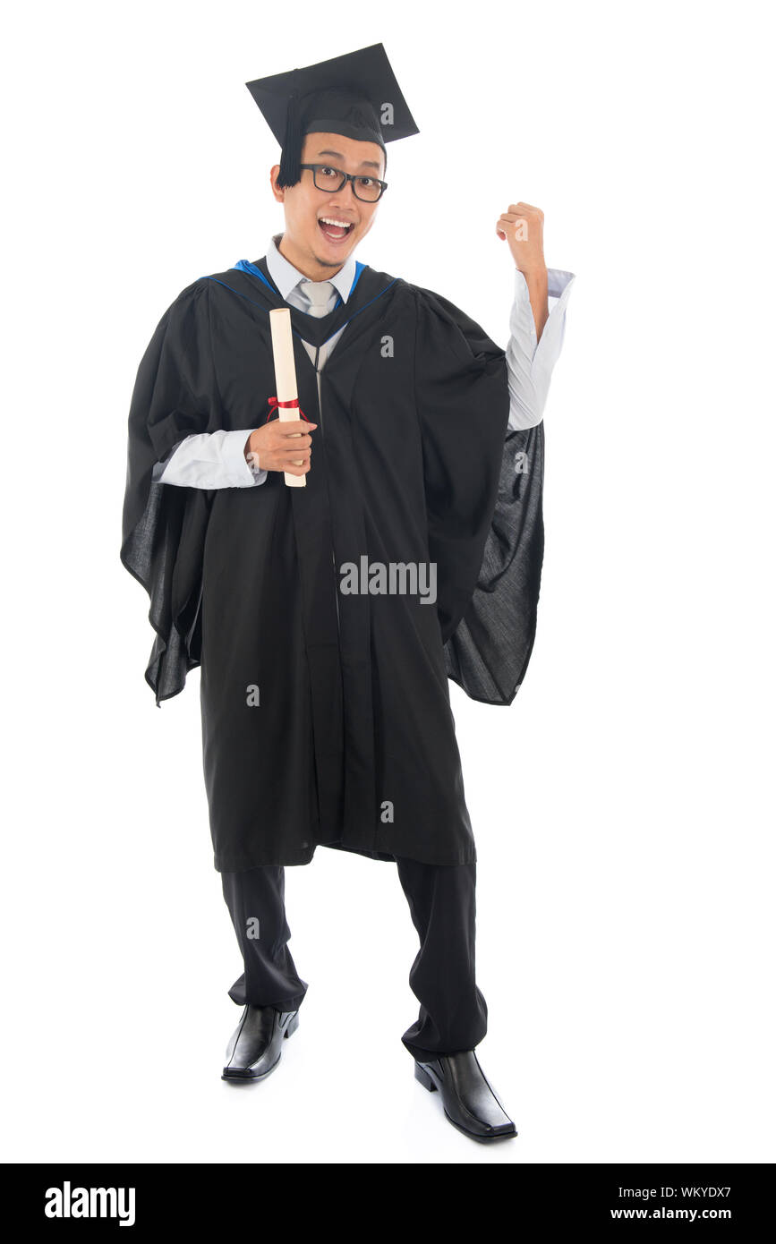 Full length happy southeast Asian university student in graduation gown ...