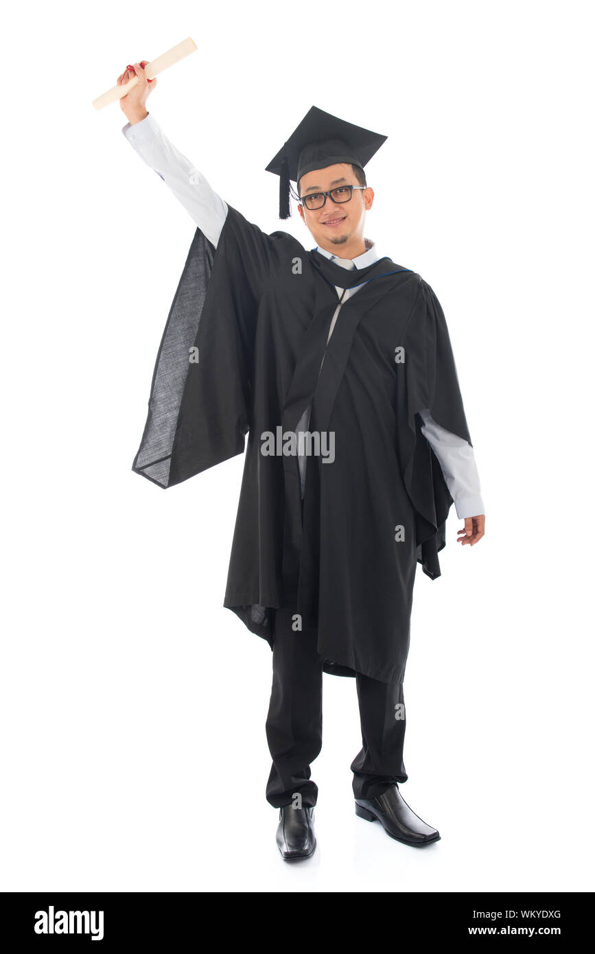 Full length Southeast Asian university student in graduation gown ...