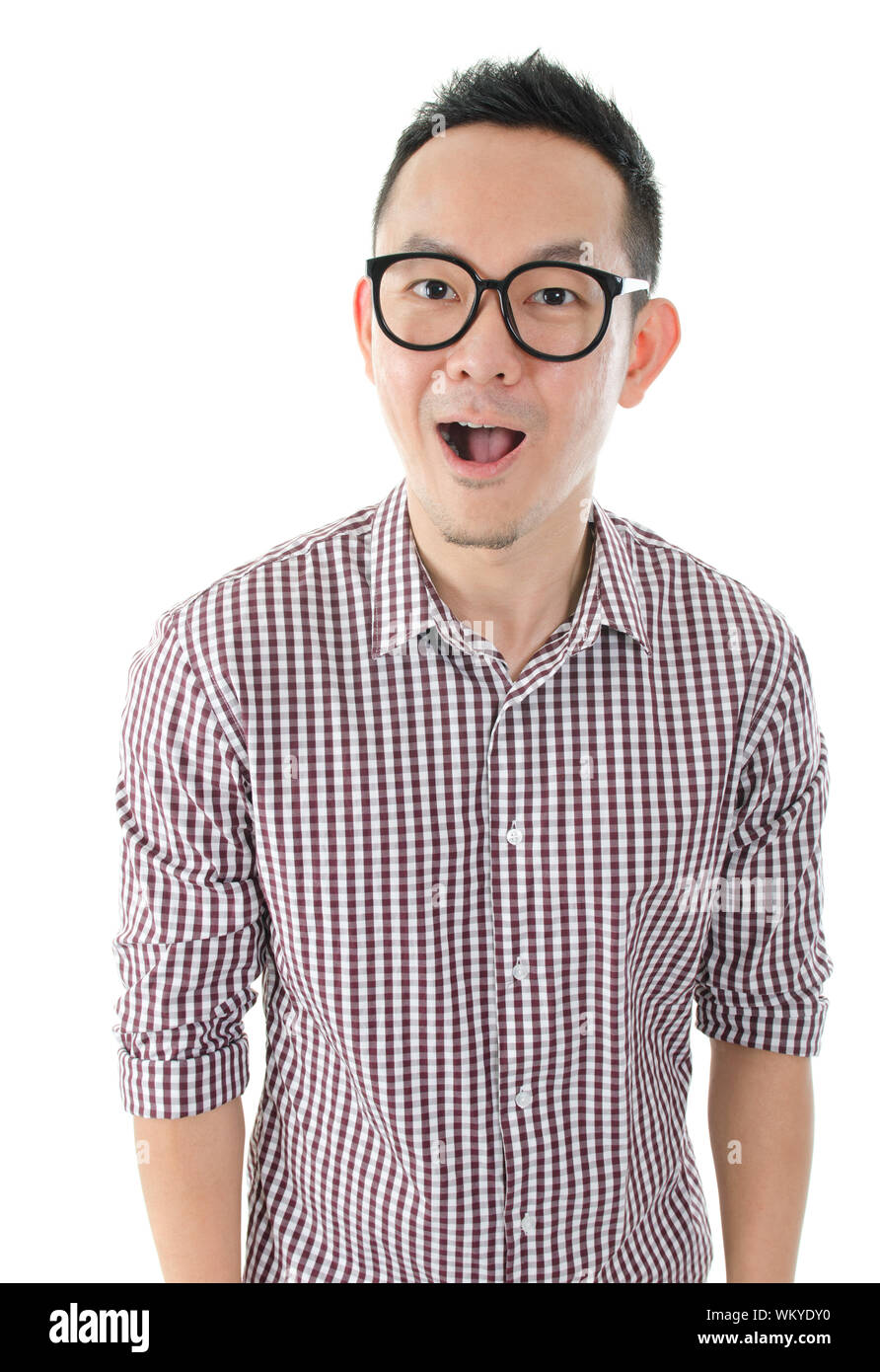 Portrait of Asian man looking at camera, shocked and standing isolated ...
