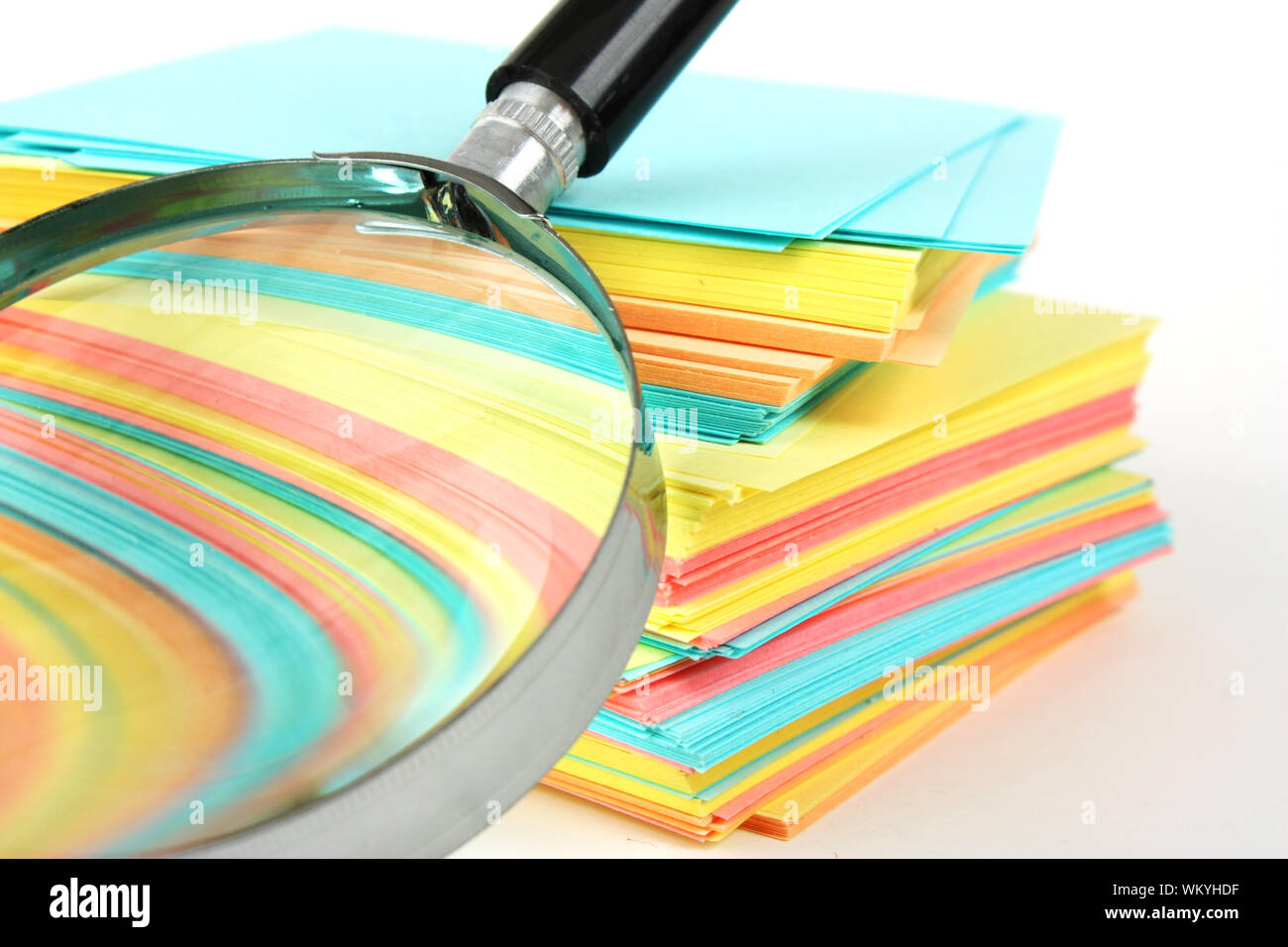 Magnifier enlarges the stack of sheets of paper Stock Photo - Alamy