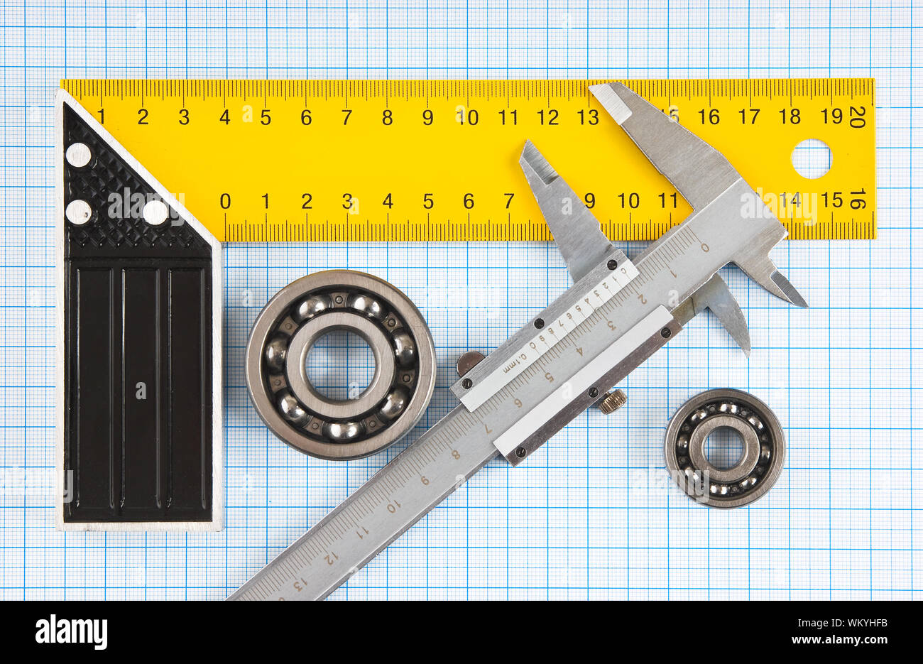 calipers, bearing and square on the background of graph paper Stock ...