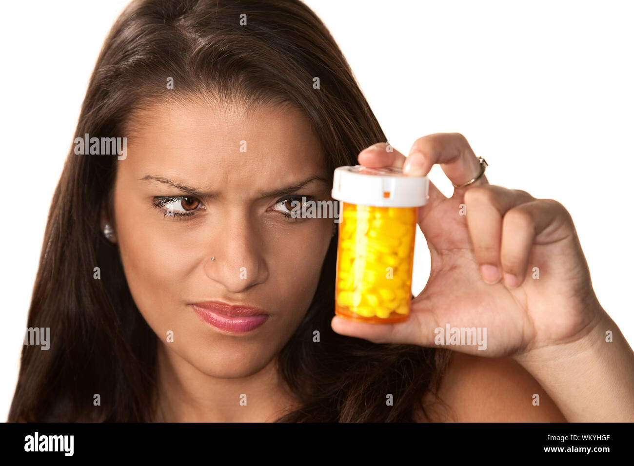 Pretty Hispanic woman reading label on prescription medication Stock ...