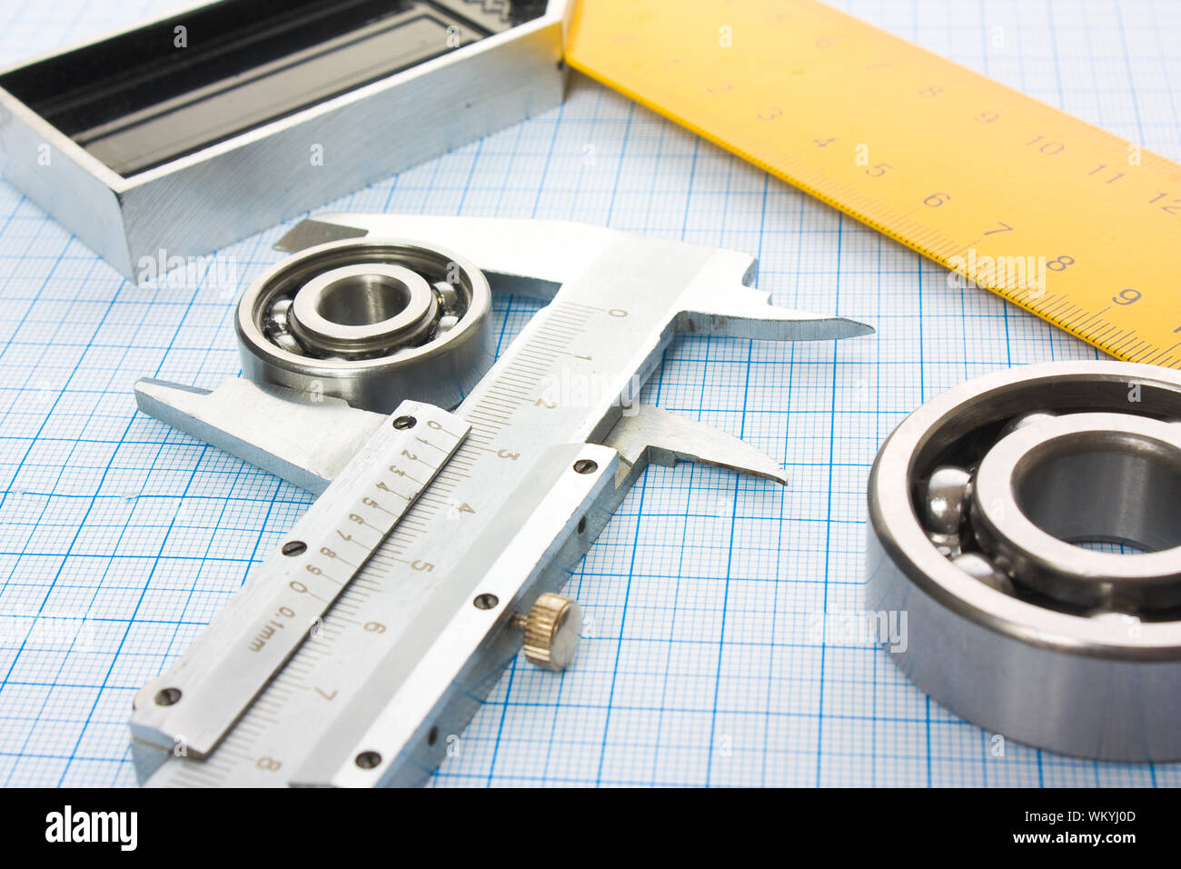 calipers, bearing and square on the background of graph paper Stock ...