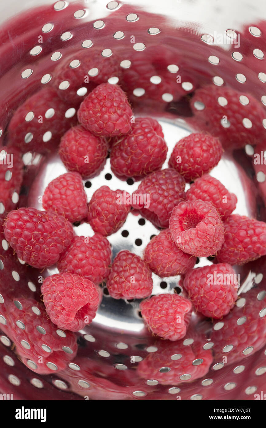 Fresh raspberries in a silver colander Stock Photo - Alamy