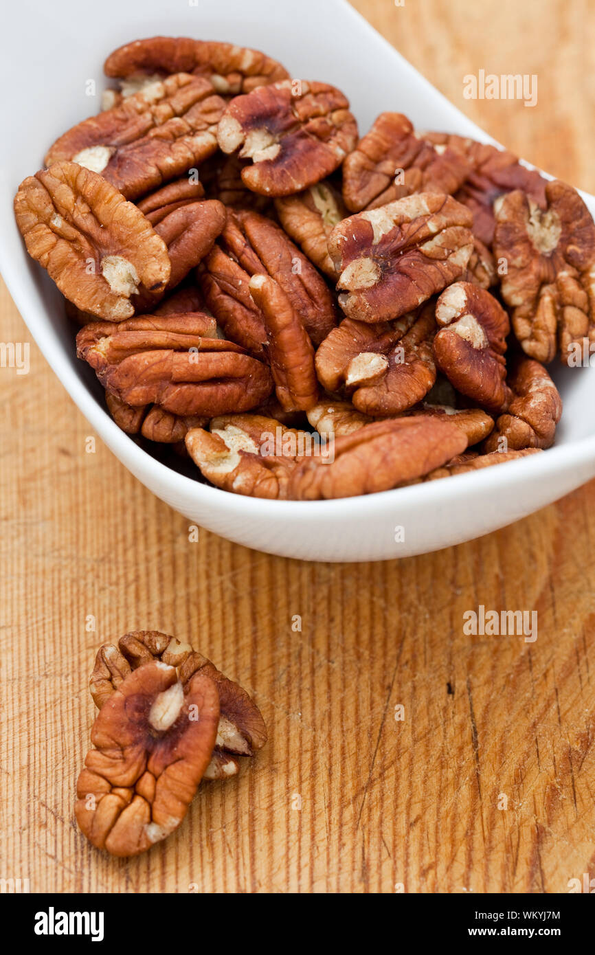 Fresh Pecan nuts in a white bowl Stock Photo - Alamy