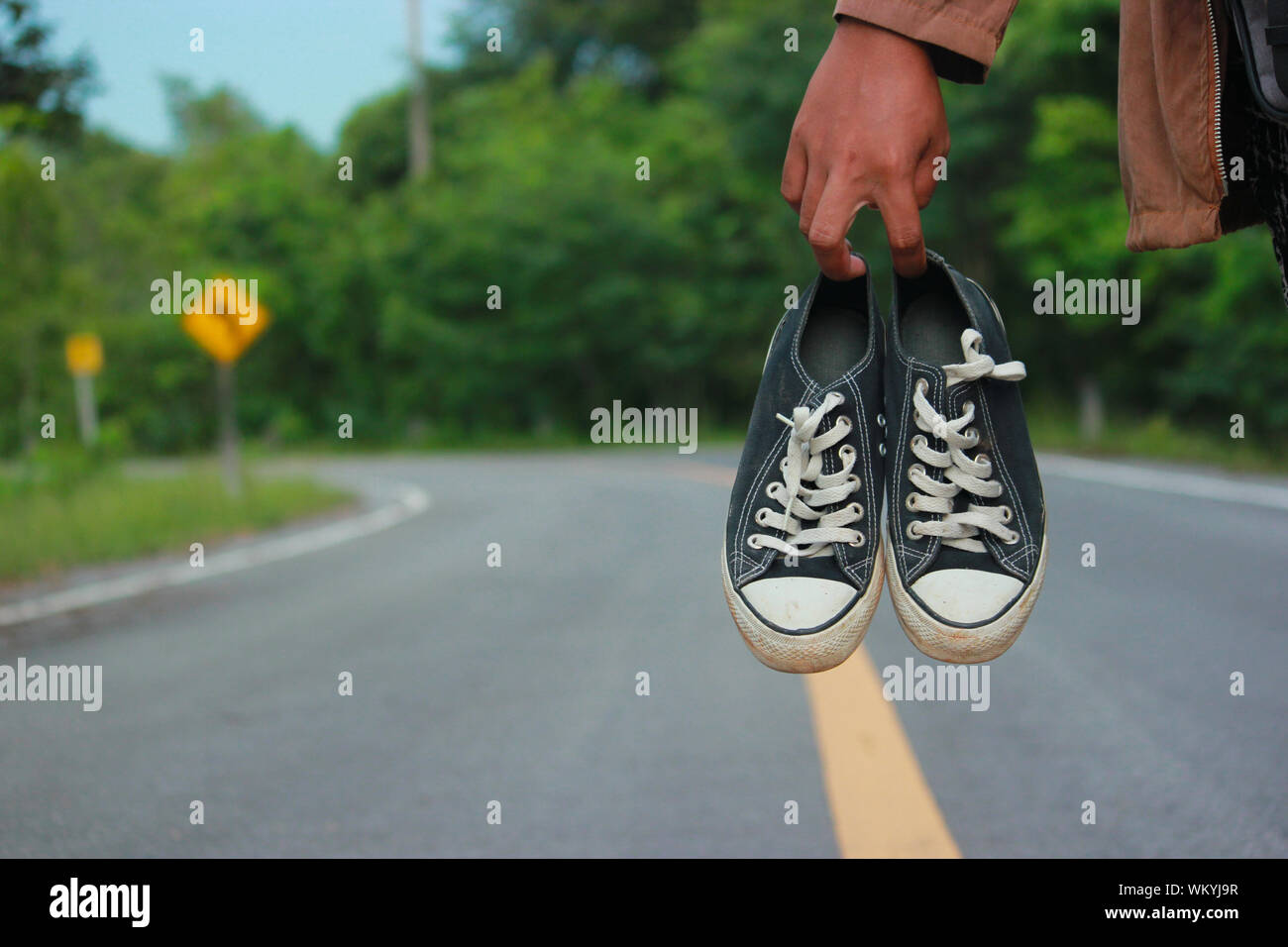 Holding shoes on hand hi-res stock photography and images - Alamy