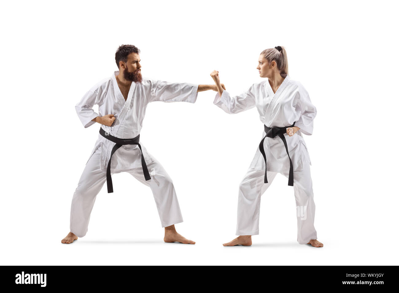Full length profile shot of a male and female practicing karate ...