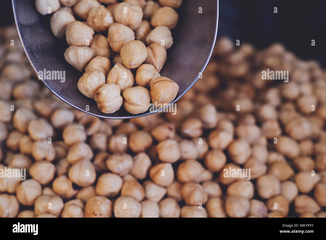 spoon with roasted hazelnuts on hazelnut background. Prepared with the ...