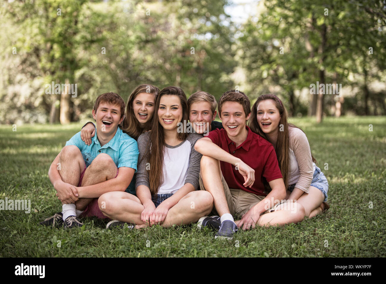 Group of young white people sitting outdoors Stock Photo - Alamy