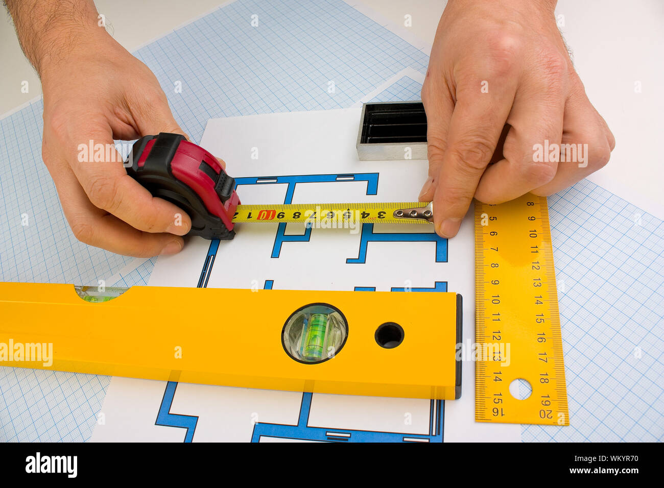 drawing at home with construction tools on a background of graph paper ...