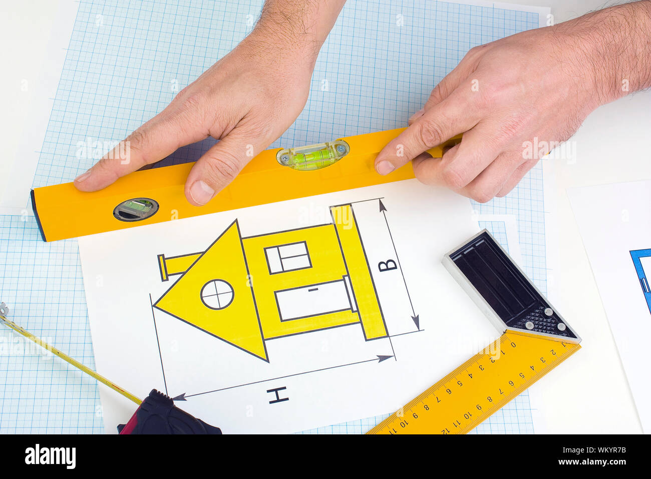 drawing at home with construction tools on a background of graph paper ...