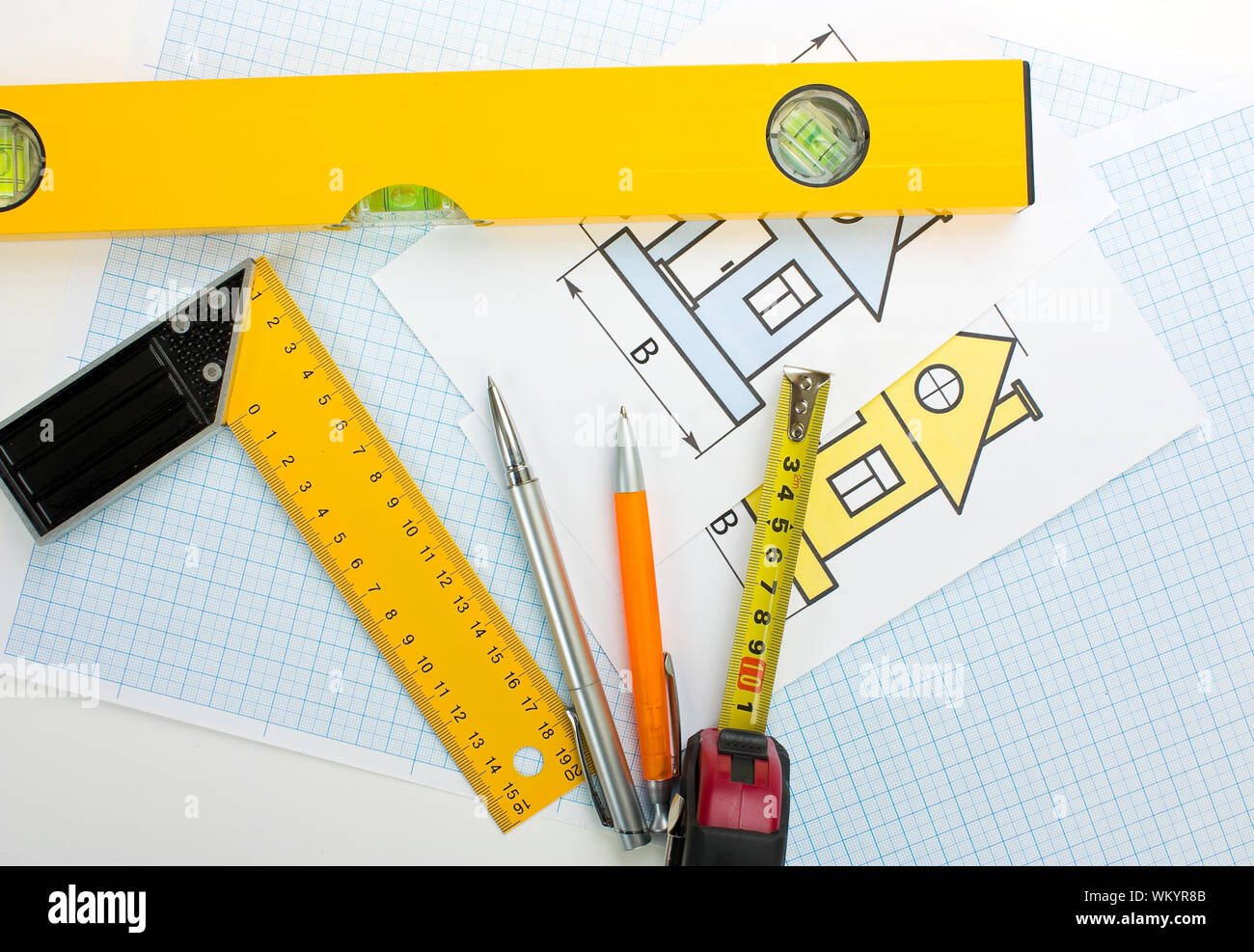 drawing at home with construction tools on a background of graph paper ...