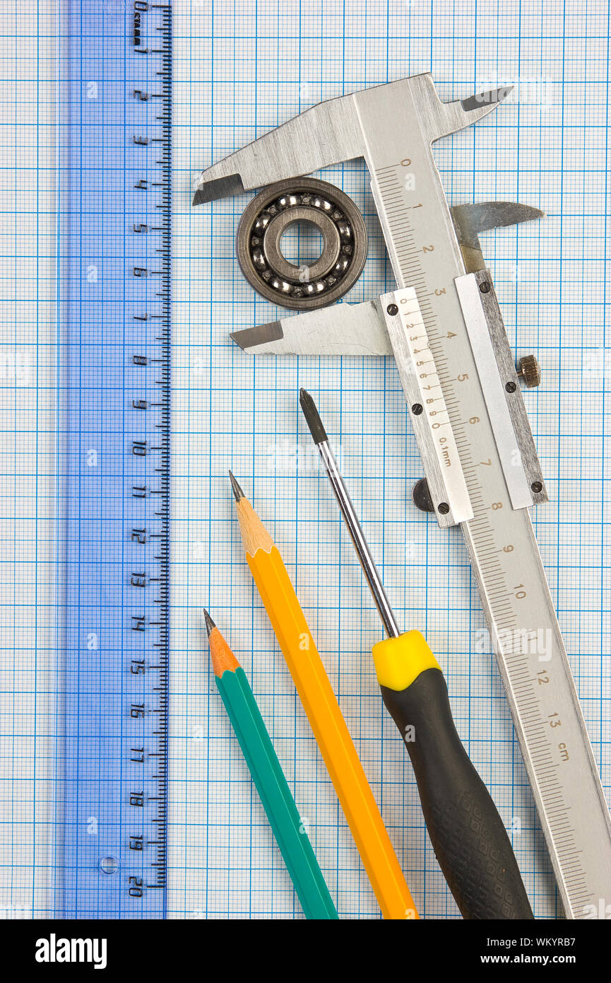 calipers, bearing and square on the background of graph paper Stock ...