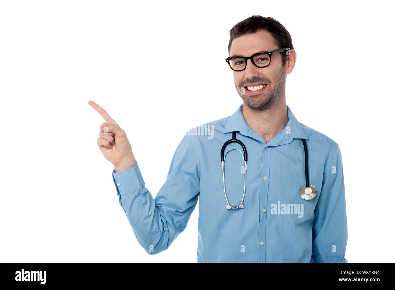 Young physician pointing away and posing to camera Stock Photo - Alamy