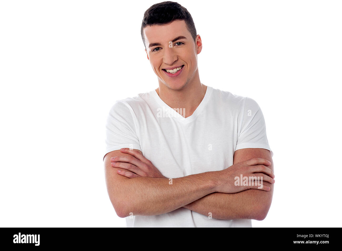 Smiling man posing with crossed arms Stock Photo - Alamy