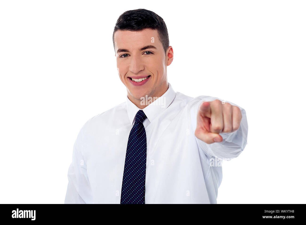 Smiling business executive pointing towards camera Stock Photo - Alamy