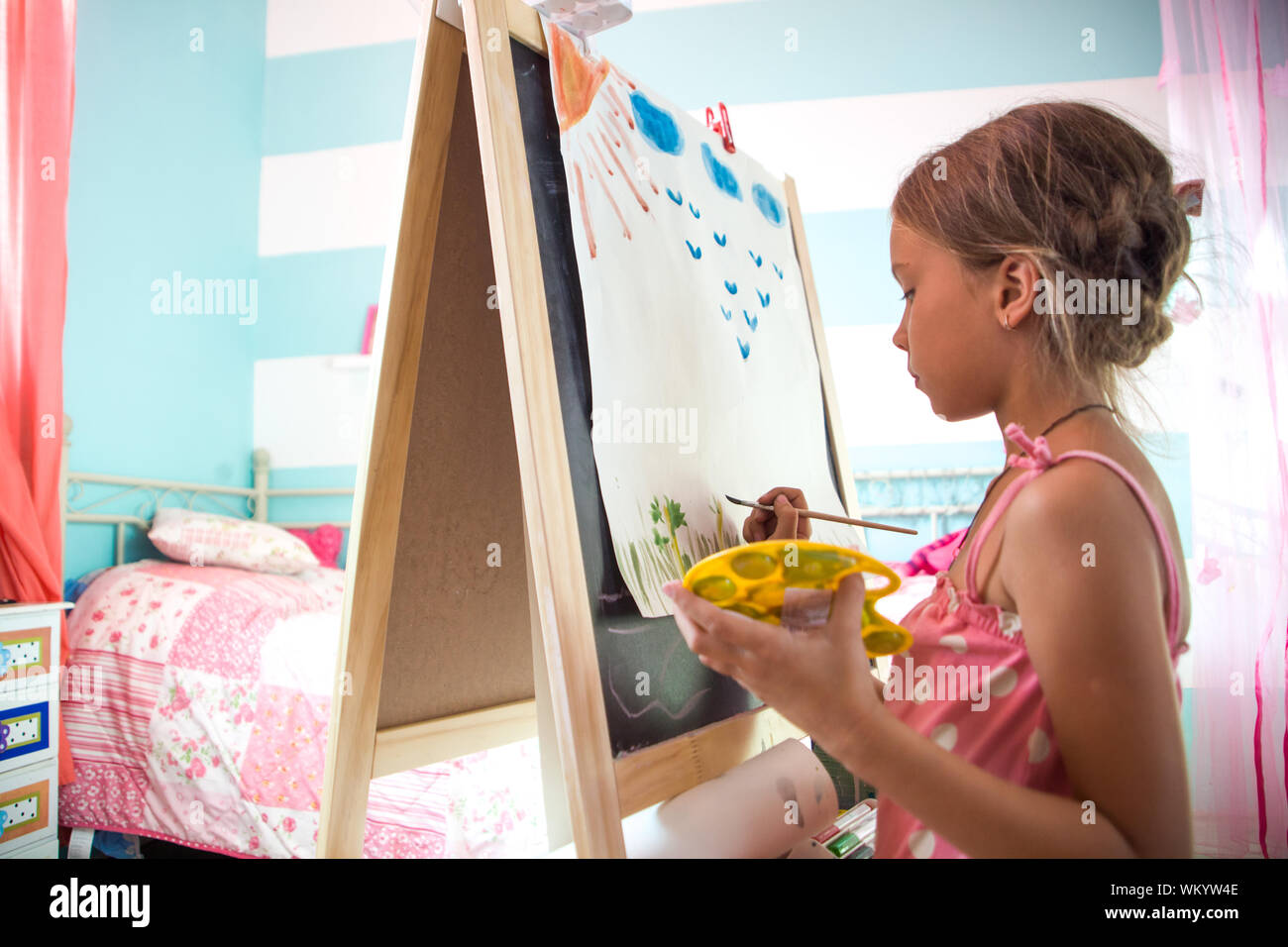 7-8 years old child drawing on easel in child room at home Stock Photo ...