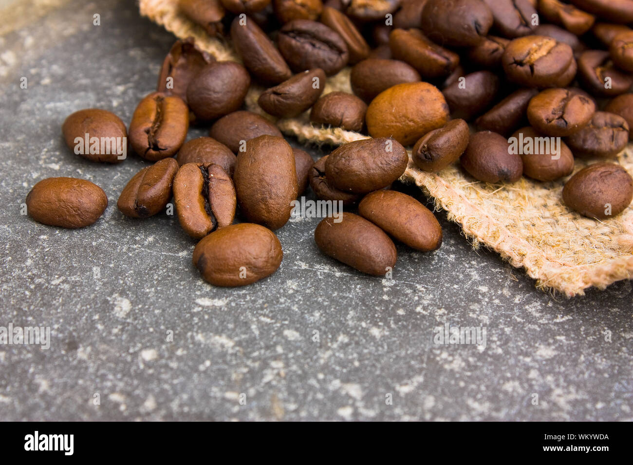 Coffee beans spilled out of the bag Stock Photo - Alamy