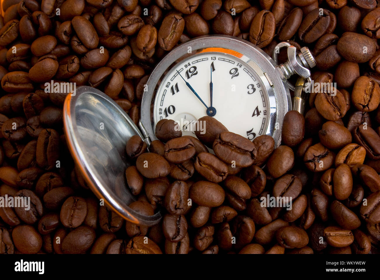 Pocket watch in coffee beans Stock Photo - Alamy