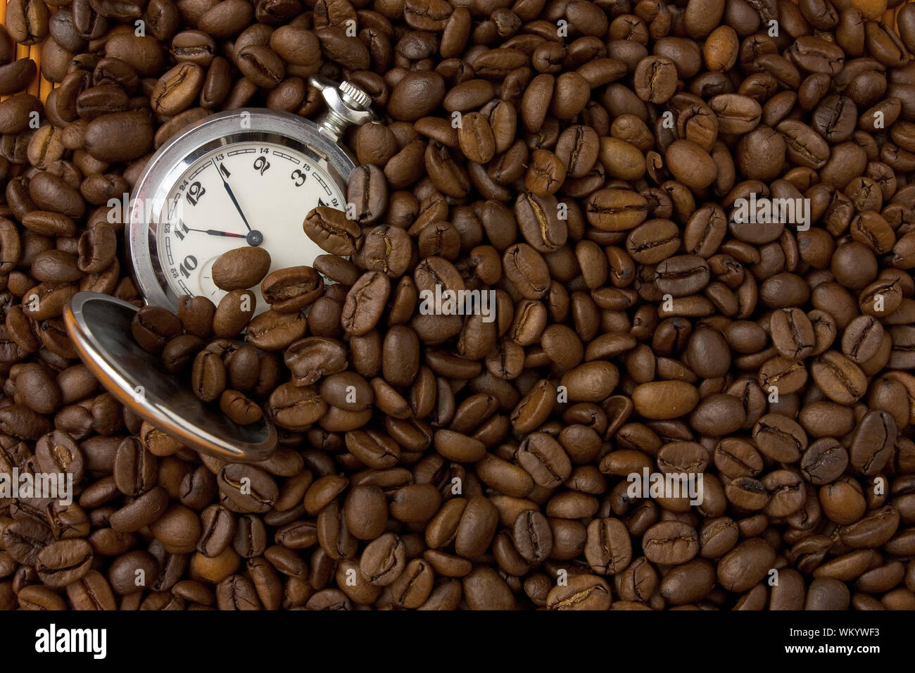 Pocket watch in coffee beans Stock Photo - Alamy