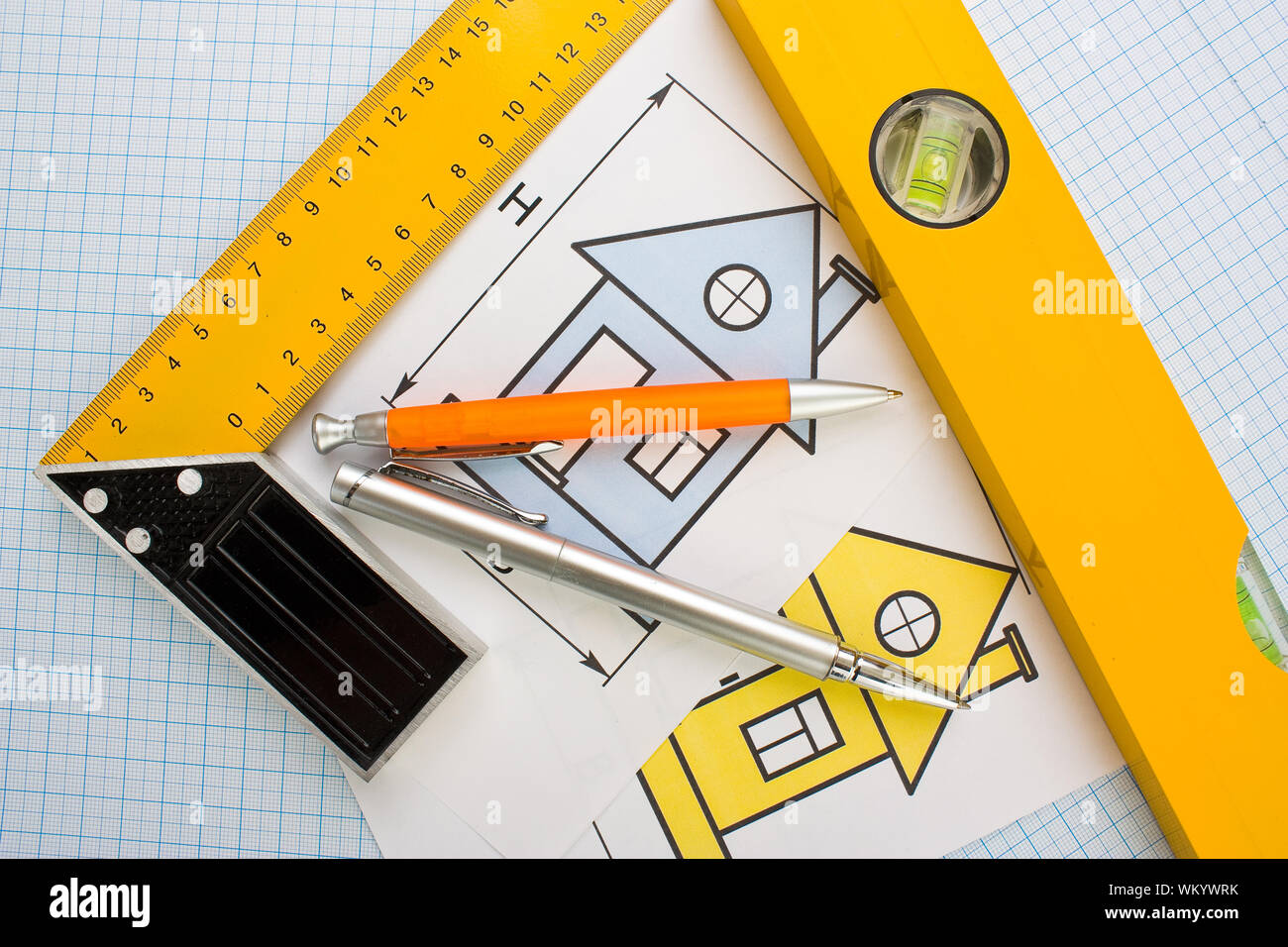 drawing at home with construction tools on a background of graph paper ...