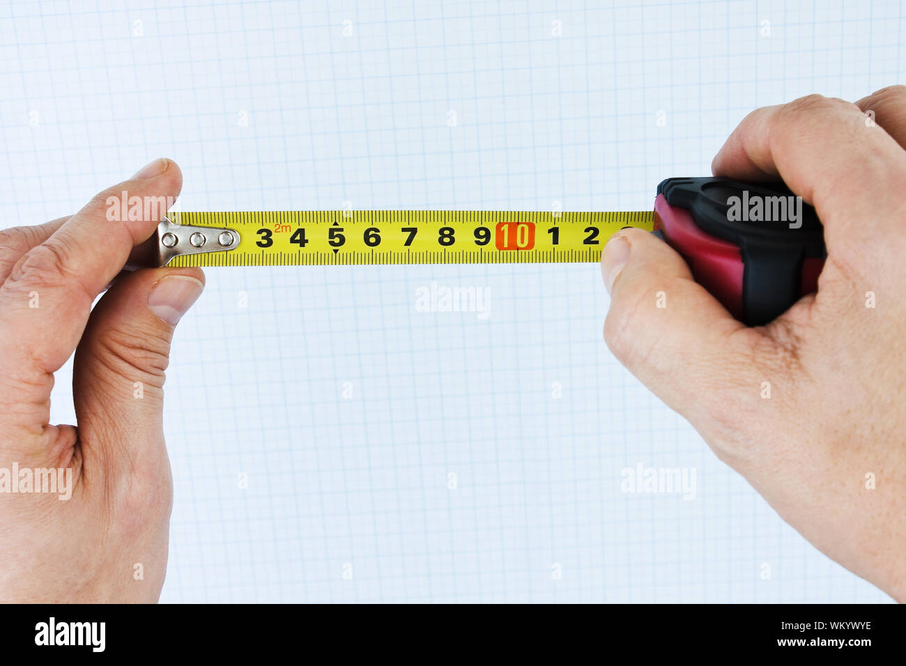 Building Roulette in the hands against the background of graph paper ...