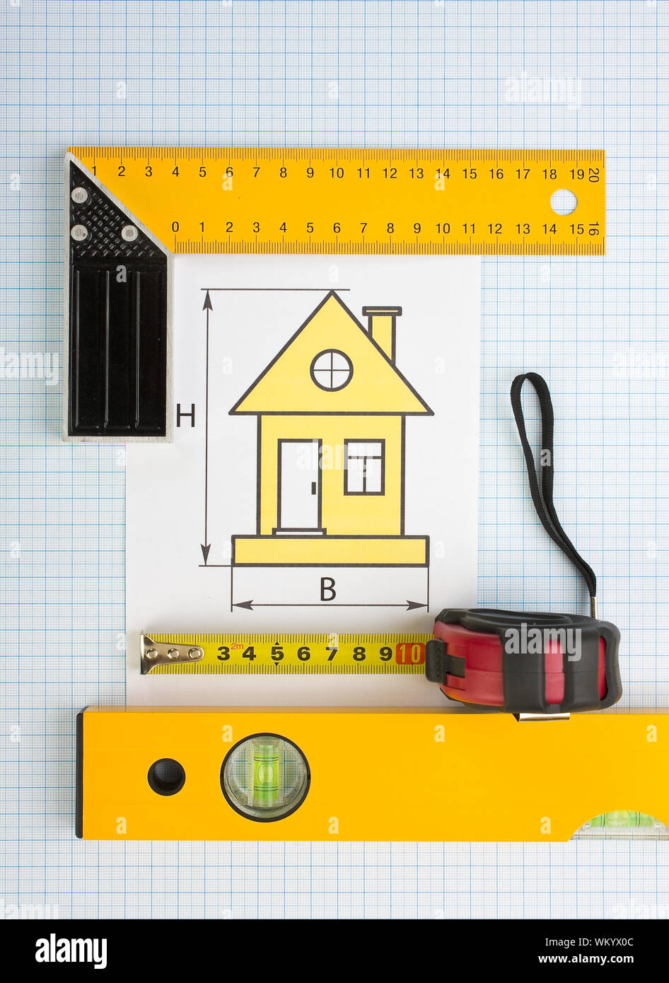 drawing at home with construction tools on a background of graph paper ...
