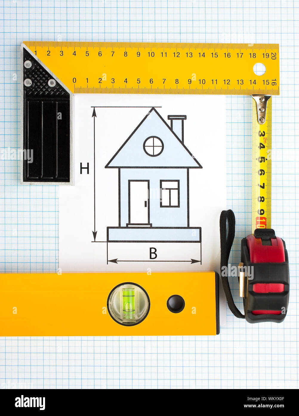 drawing at home with construction tools on a background of graph paper ...