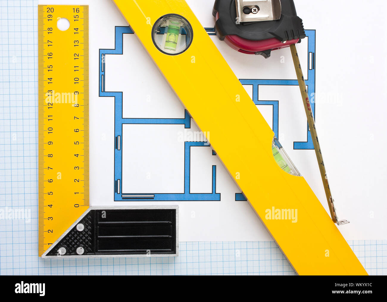 drawing at home with construction tools on a background of graph paper ...