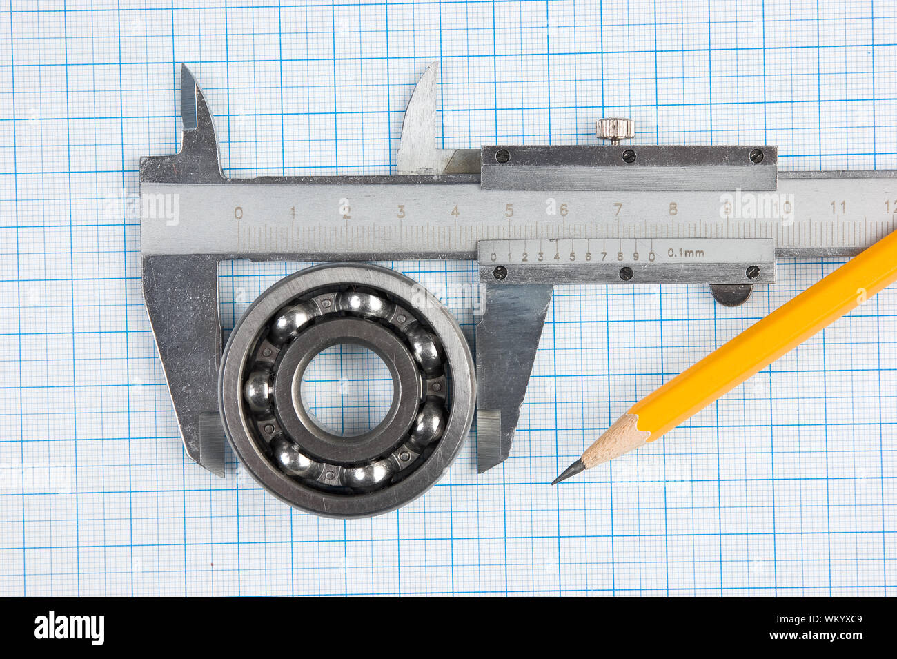 calipers, bearing and square on the background of graph paper Stock ...