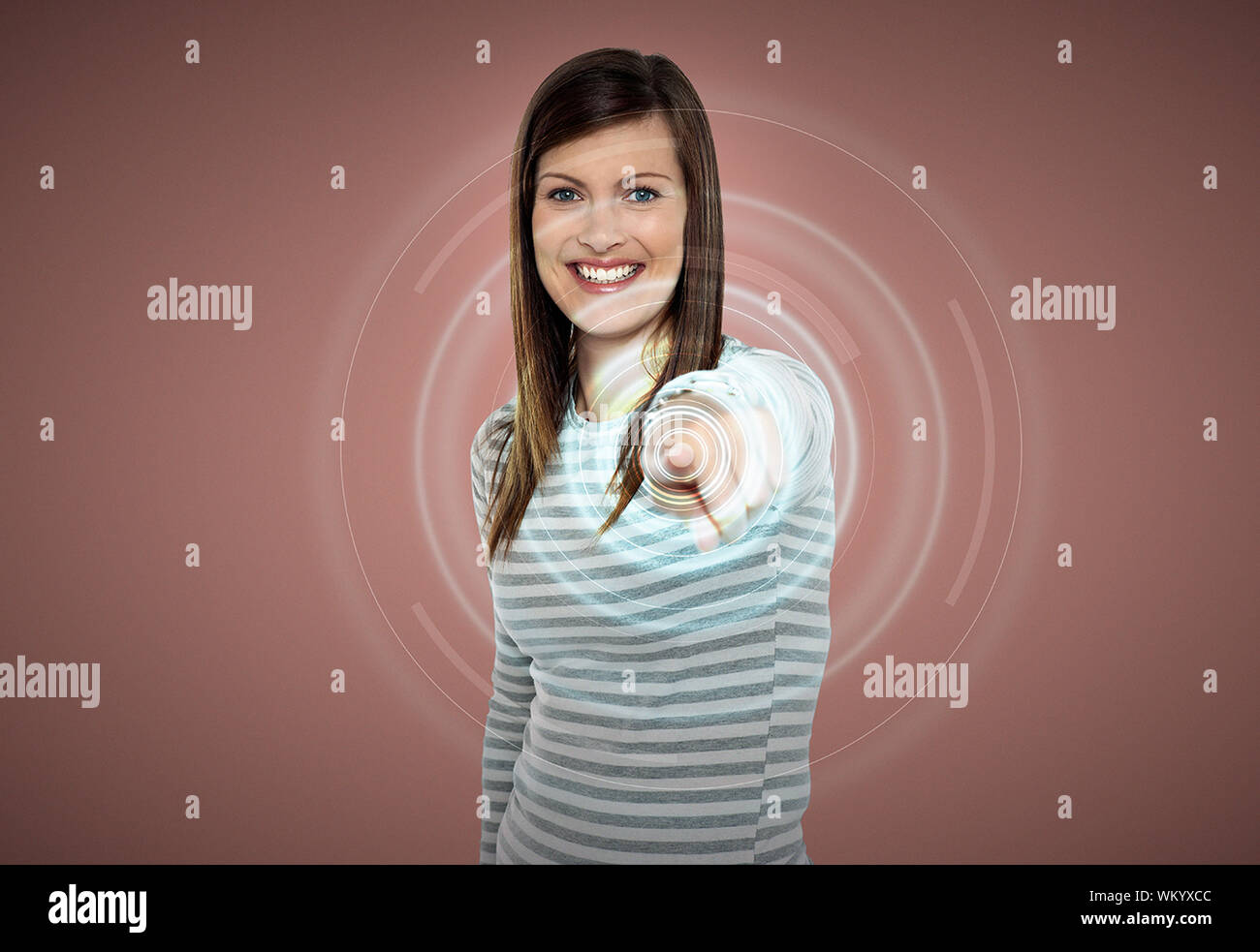 Beautiful woman pointing her finger on virtual screen Stock Photo - Alamy