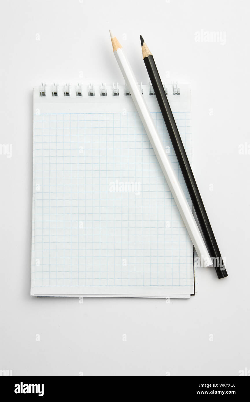 Pencils and notepad isolated on white background Stock Photo - Alamy