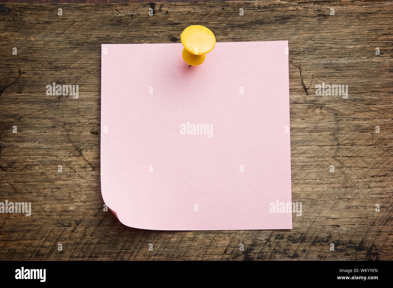 A piece of paper pinned the button on the board Stock Photo - Alamy