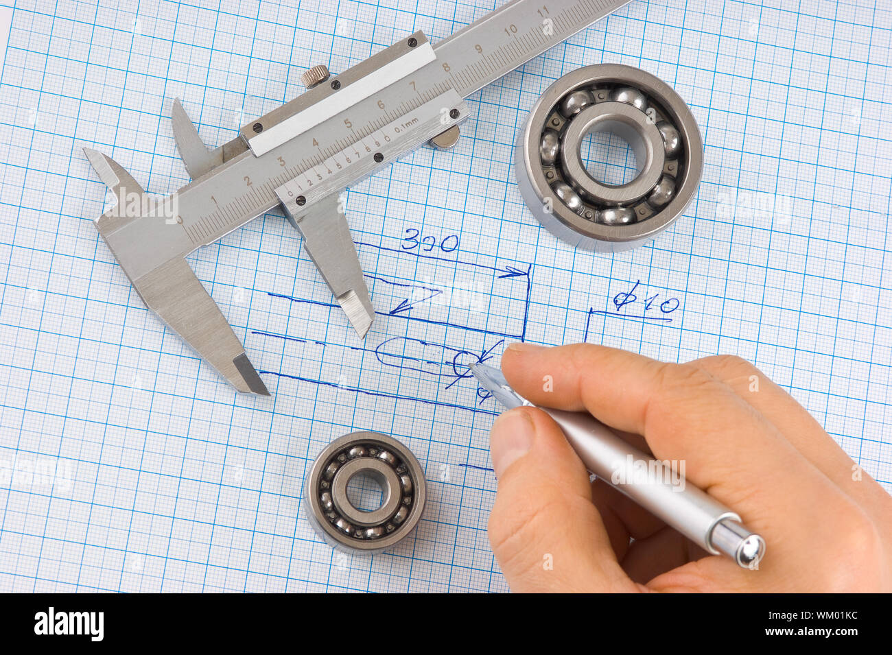 calipers, bearing and square on the background of graph paper Stock ...